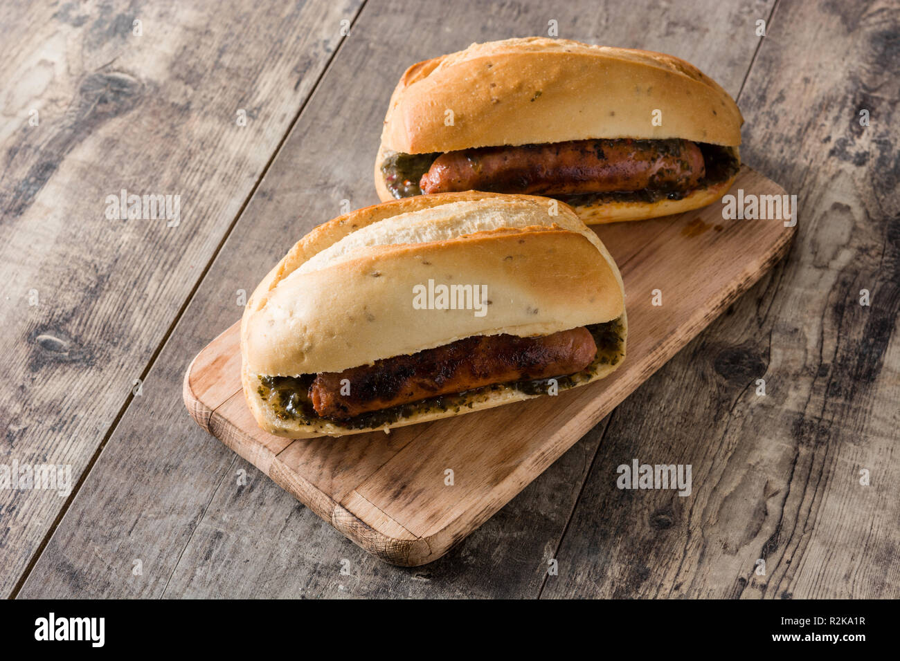 Choripan. Traditional Argentina sandwich with chorizo and chimichurri ...