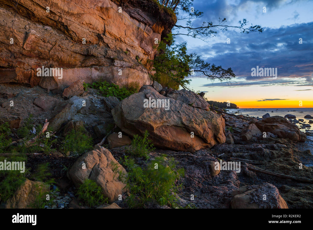 Late sunset over the limestone cliff along the sea. Estonia Stock Photo ...