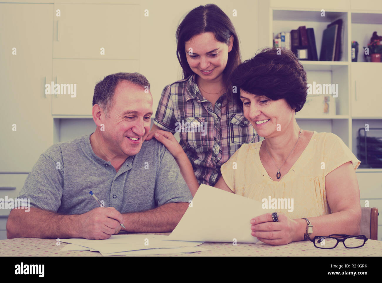 Daughter helping senior parents hi-res stock photography and images - Alamy