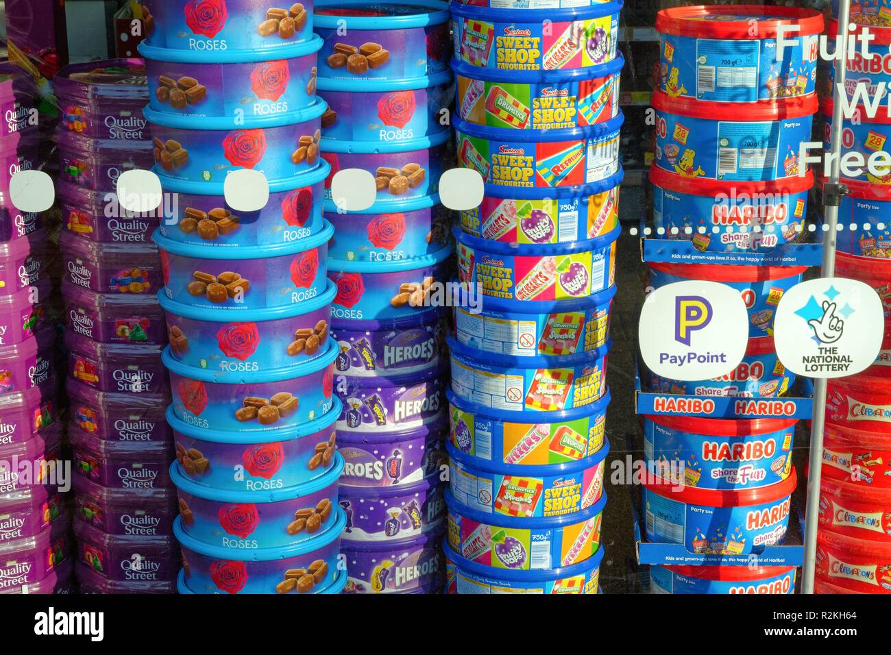 Tins of confectionery on display in a food store window Surrey England ...