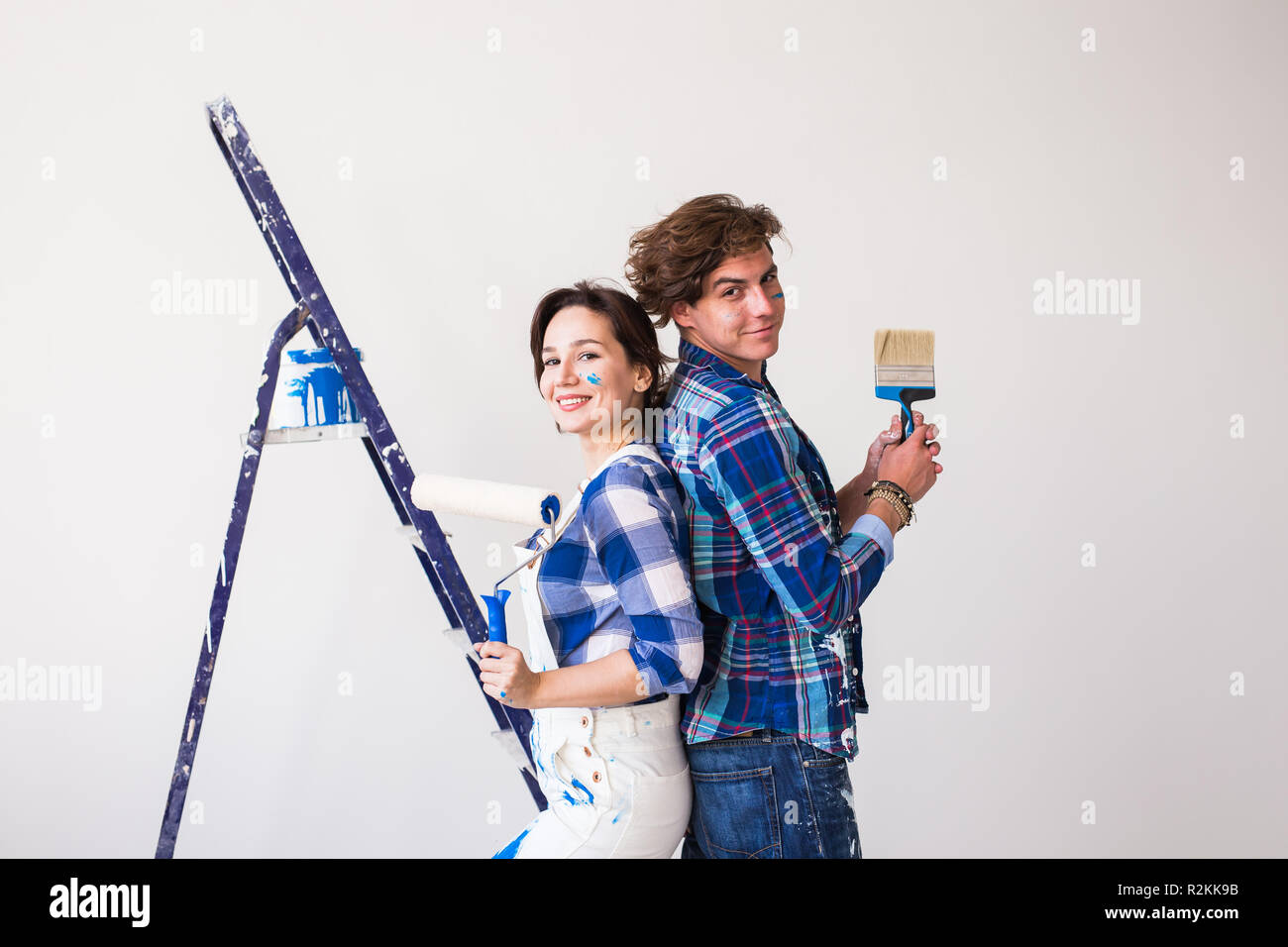 Teamwork, repair and renovation concept - Man and woman covered in ...