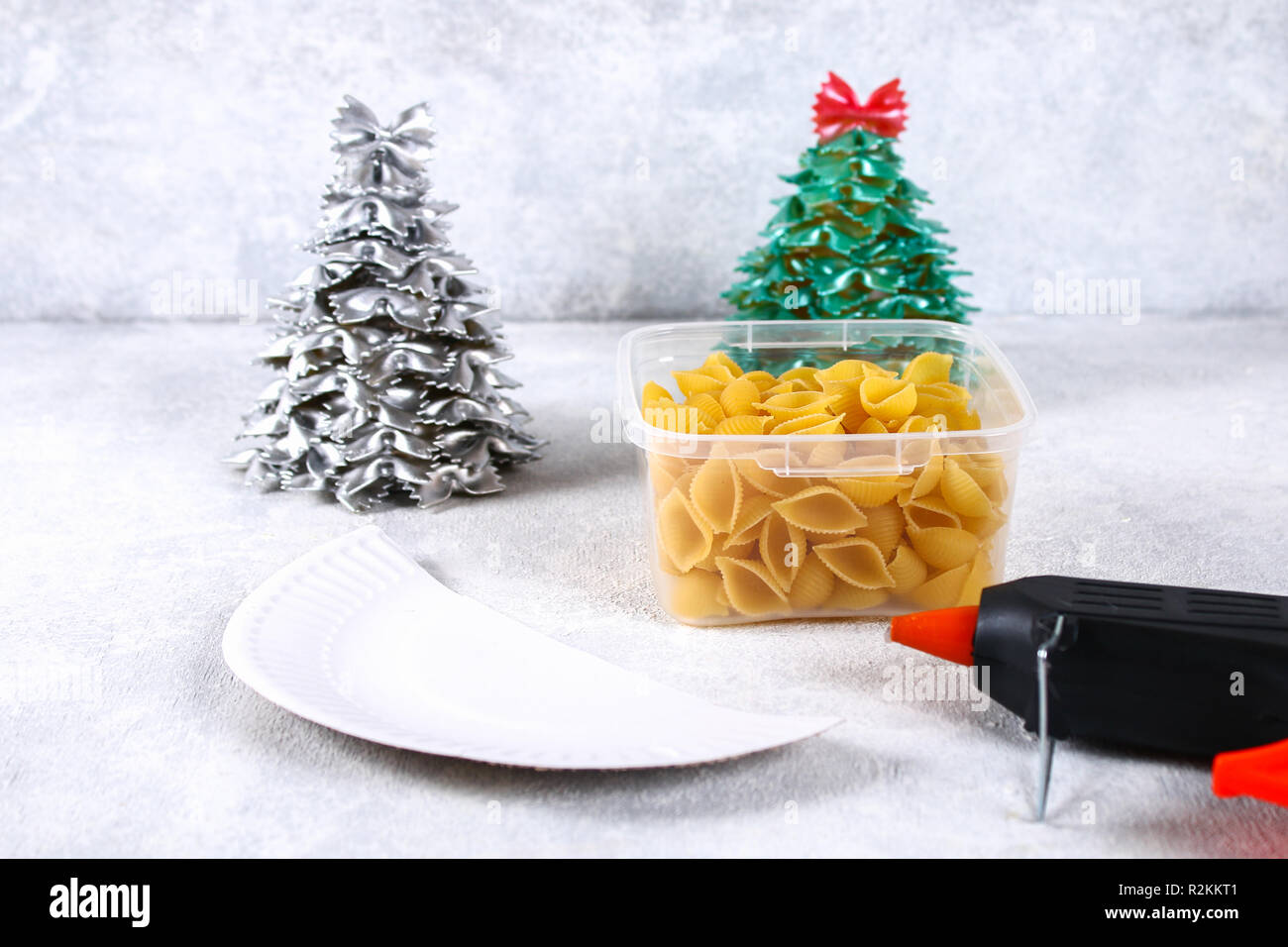 How to make a Christmas tree from raw pasta conchiglie. The process of ...