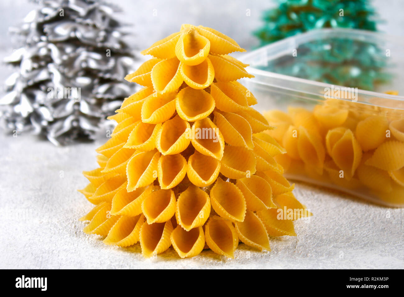 How to make a Christmas tree from raw pasta conchiglie. The process of ...