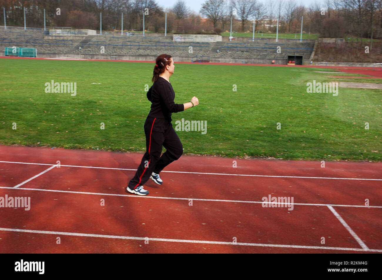 young woman running in the stadium Stock Photo - Alamy