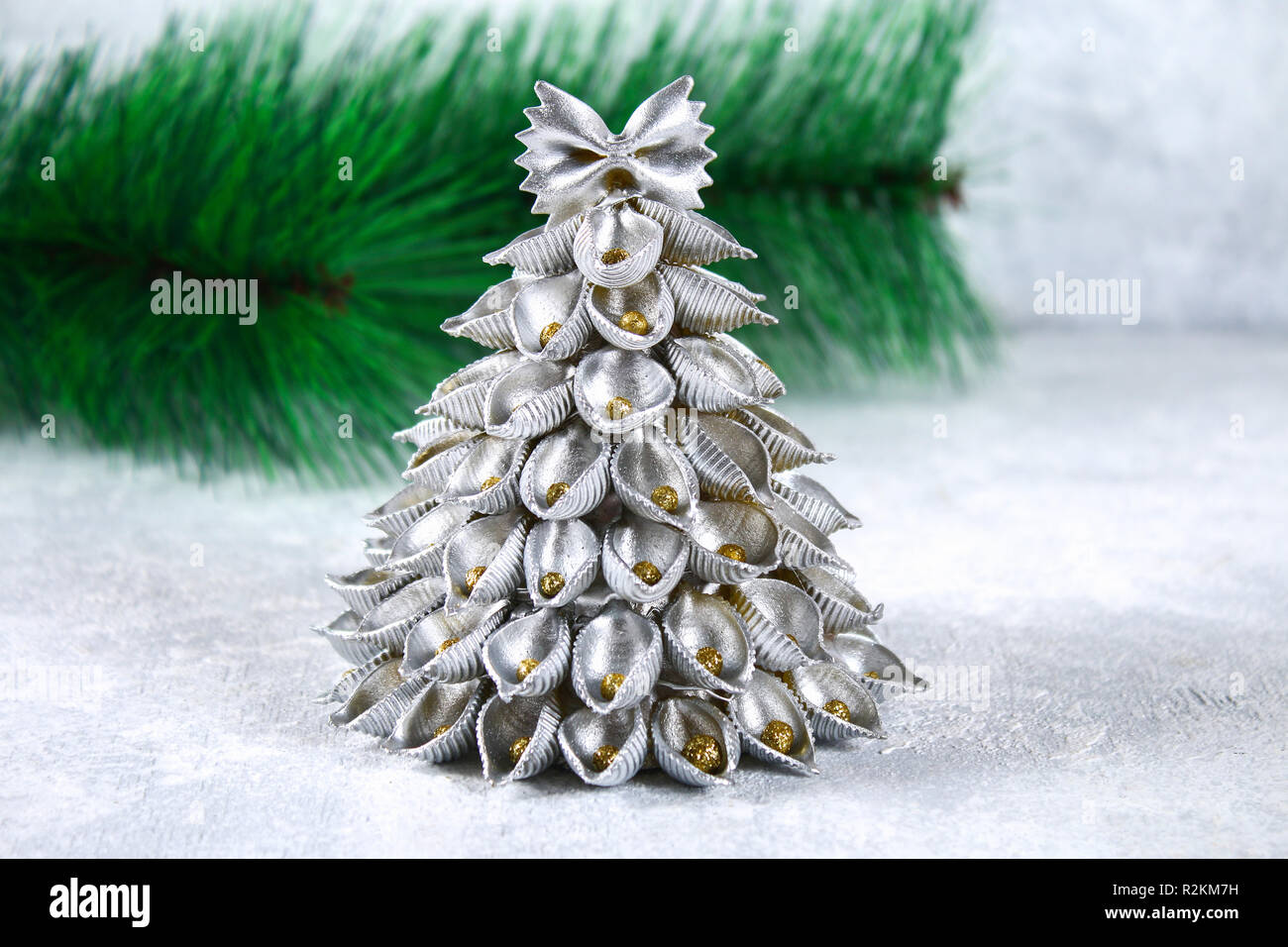 How to make a Christmas tree from raw pasta conchiglie. The process of ...