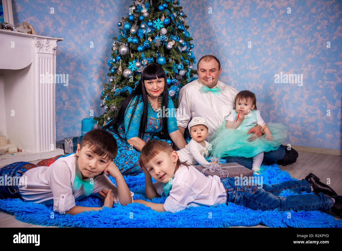 Family gathered around christmas tree hi-res stock photography and ...