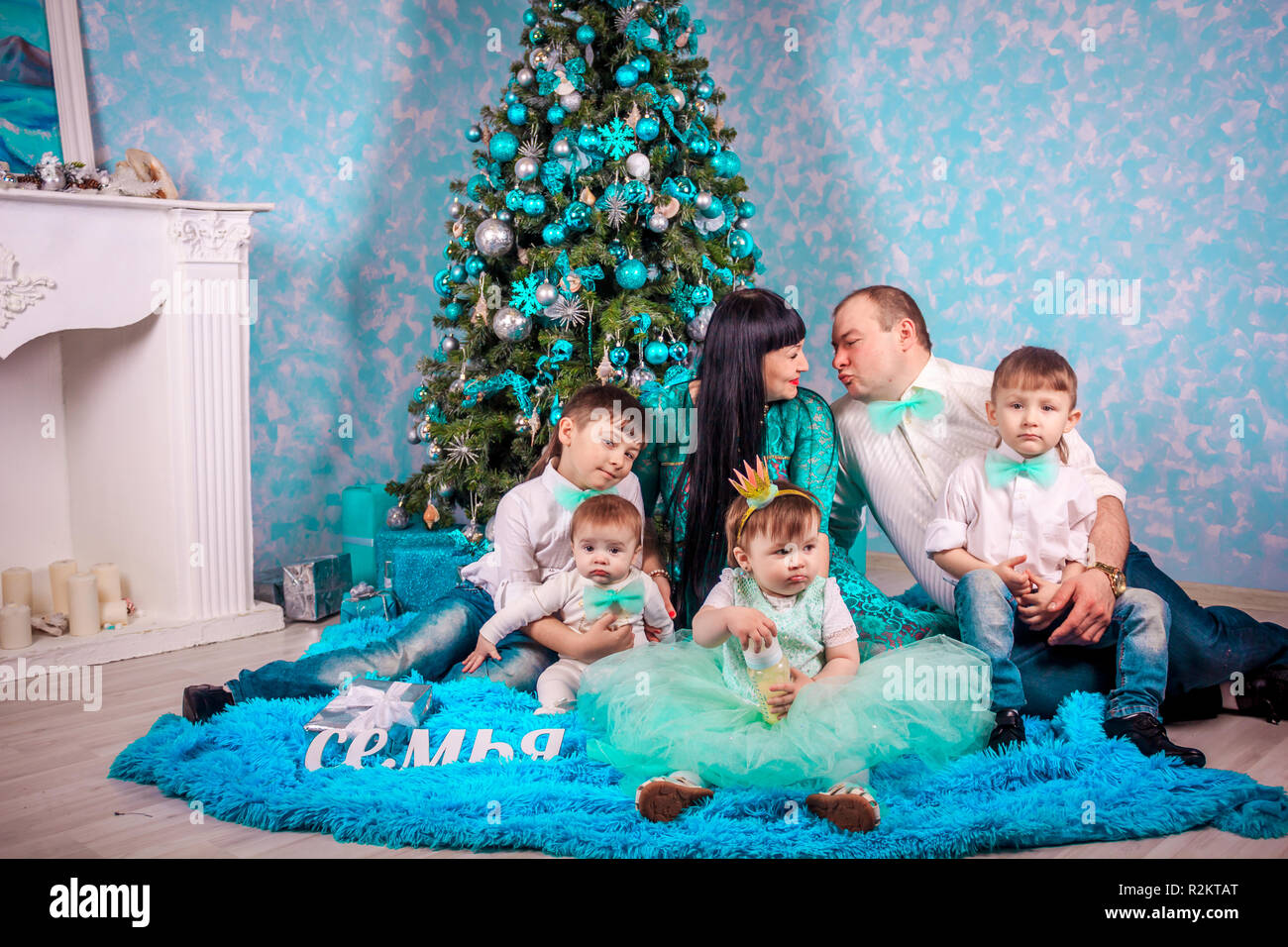 Family gathered around christmas tree hi-res stock photography and ...