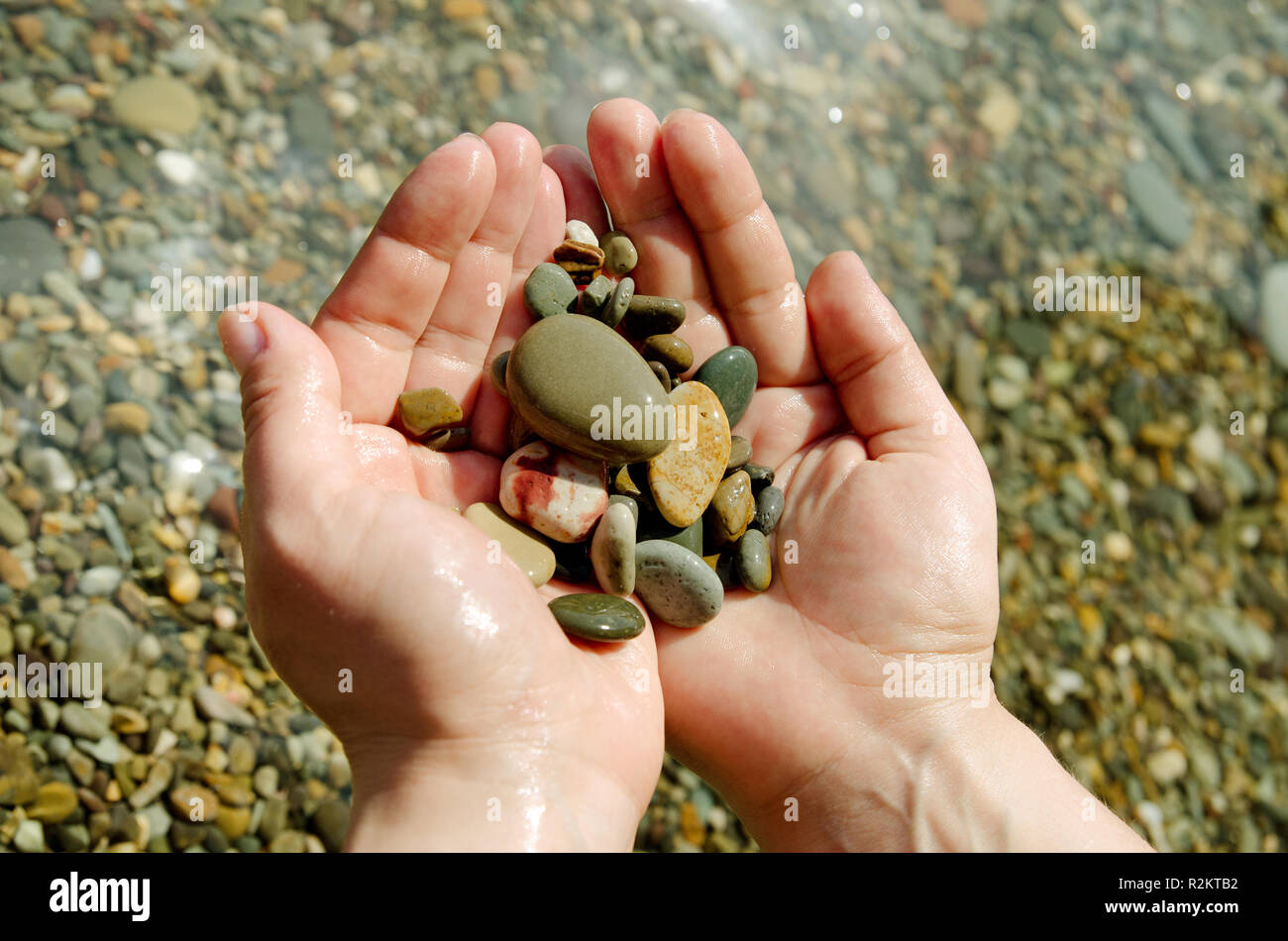 Pebble in hand hi-res stock photography and images - Alamy