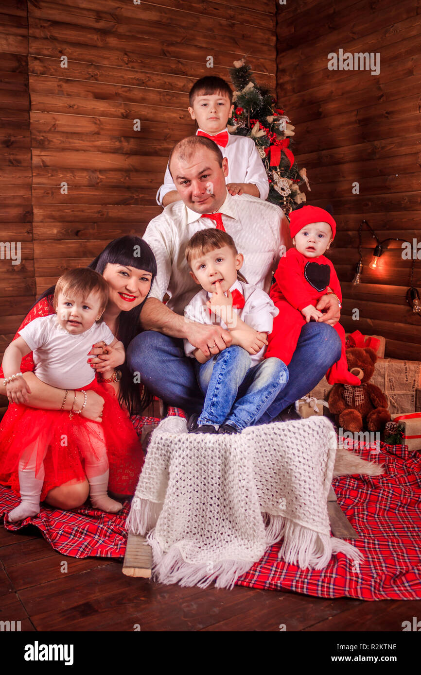 Family gathered around christmas tree hi-res stock photography and ...