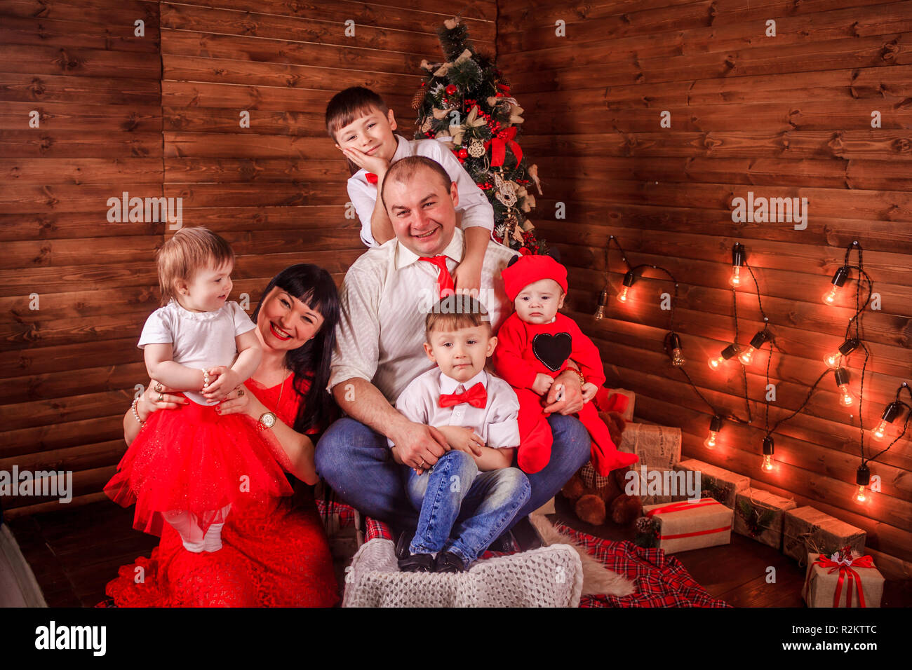 Family gathered around christmas tree hi-res stock photography and ...