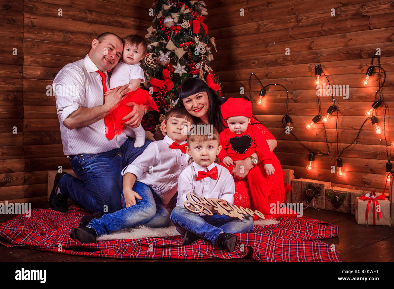 Family gathered around christmas tree hi-res stock photography and ...