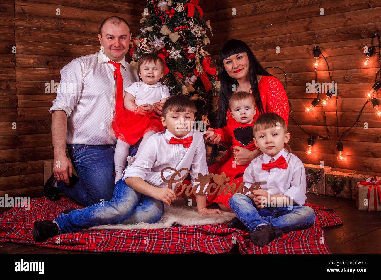 Family gathered around christmas tree hi-res stock photography and ...