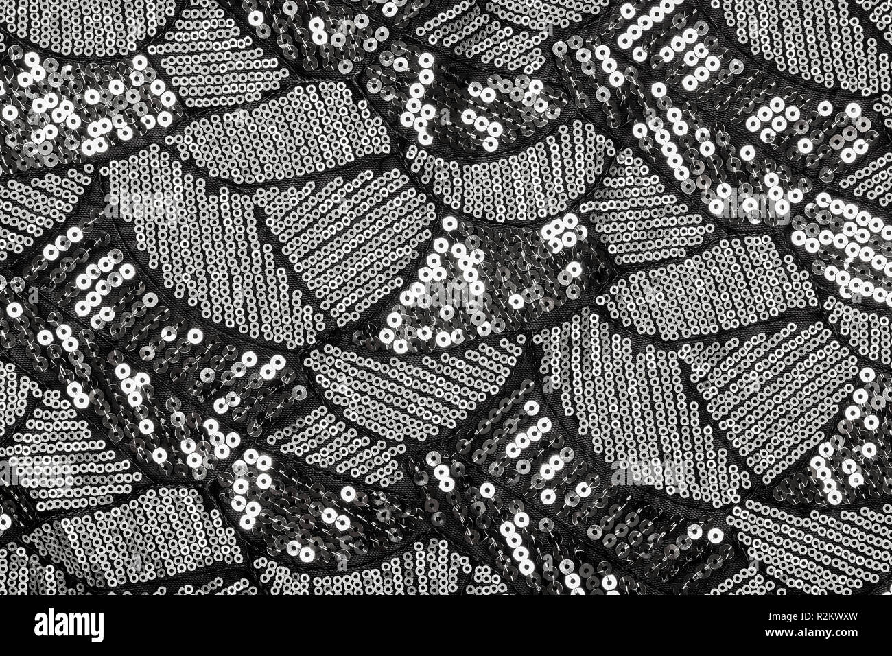 Black fabric with shiny silver sequin design. Glitter fashion ...