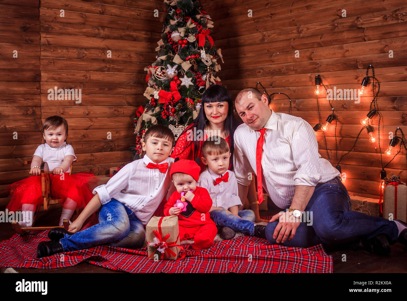 Family gathered around christmas tree hi-res stock photography and ...