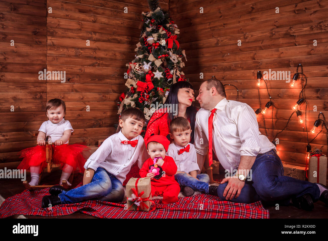 Family gathered around christmas tree hi-res stock photography and ...