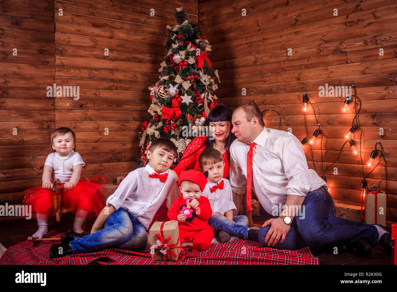 Family gathered around christmas tree hi-res stock photography and ...