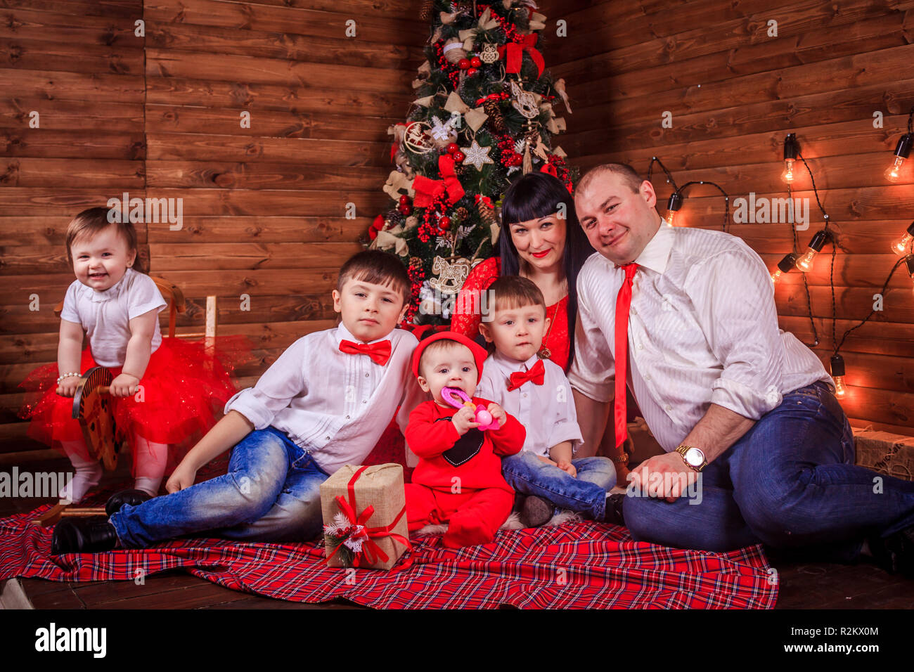Family gathered around christmas tree hi-res stock photography and ...