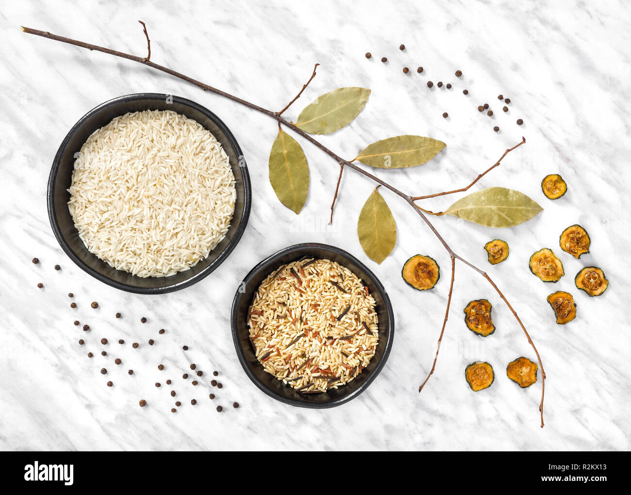 Styled cooking ingredients on marble background. Rice, laurel leaves ...