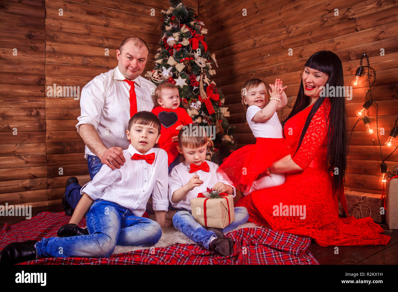 Family gathered around christmas tree hi-res stock photography and ...