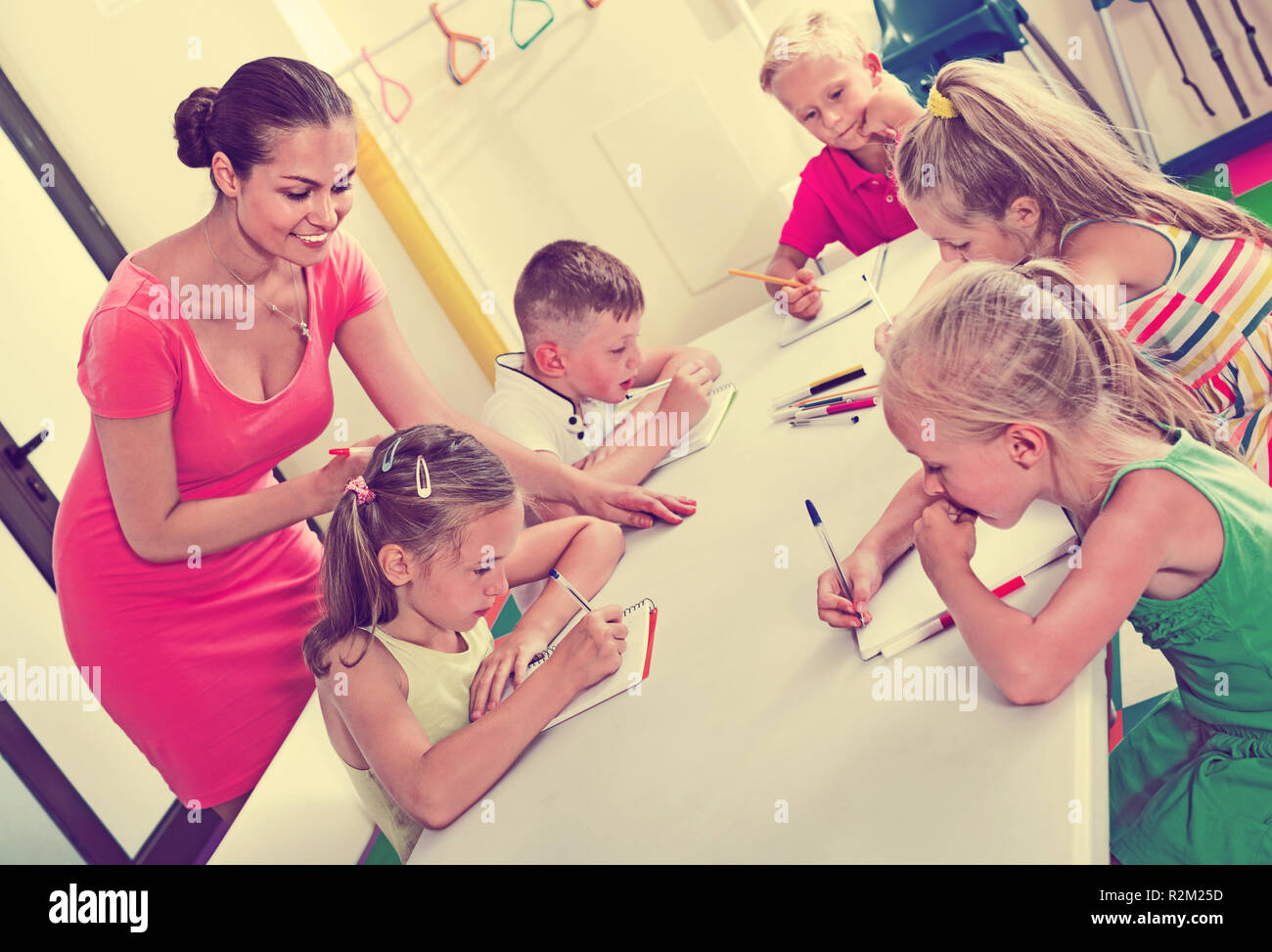 Diligent kids learning to write on lesson in elementary school class ...
