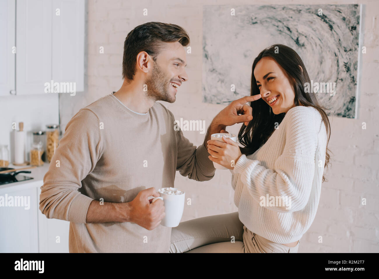 happy young couple with cocoa and pancakes cuddling on kitchen Stock ...