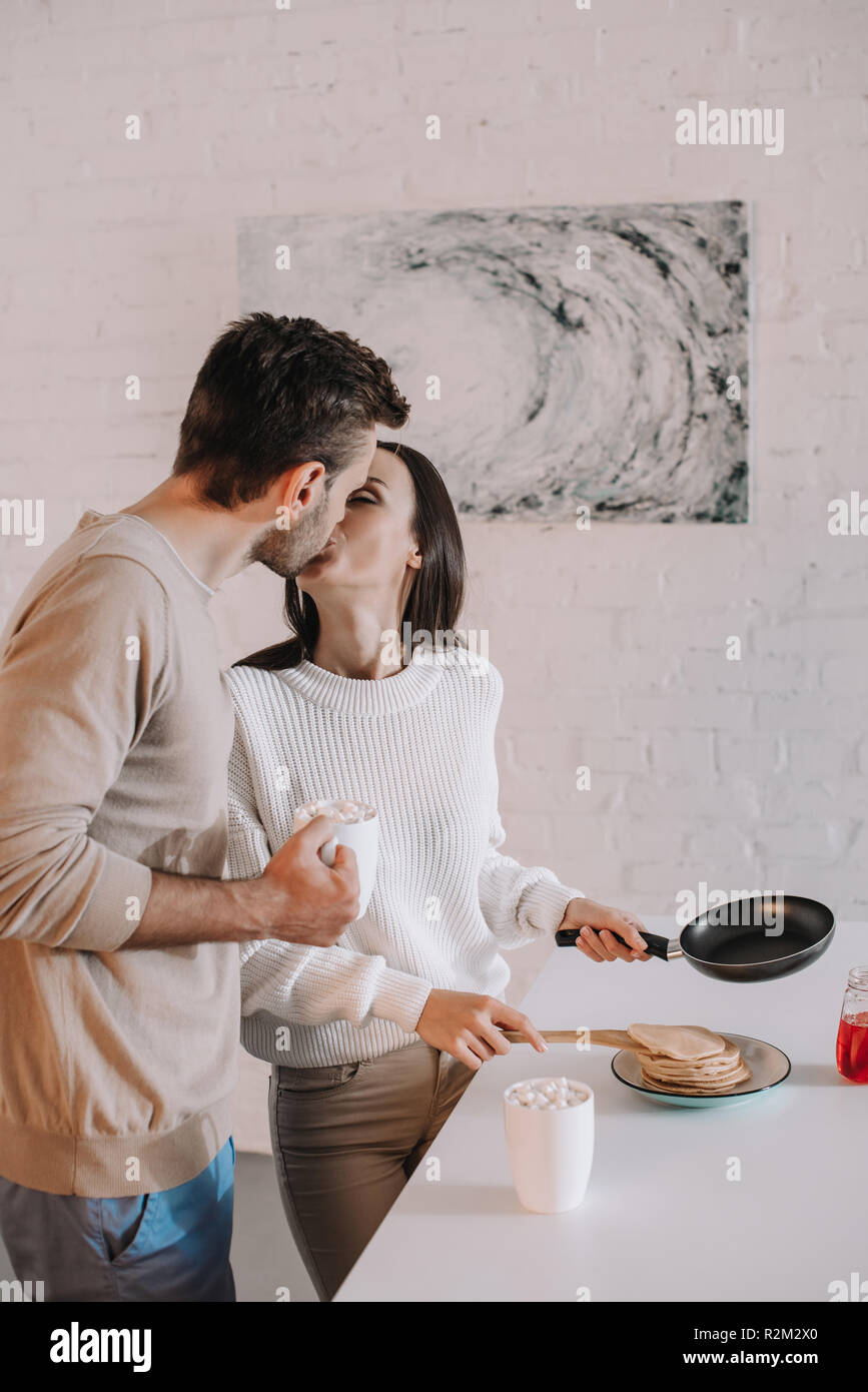 beautiful young couple making breakfast together and kissing Stock ...