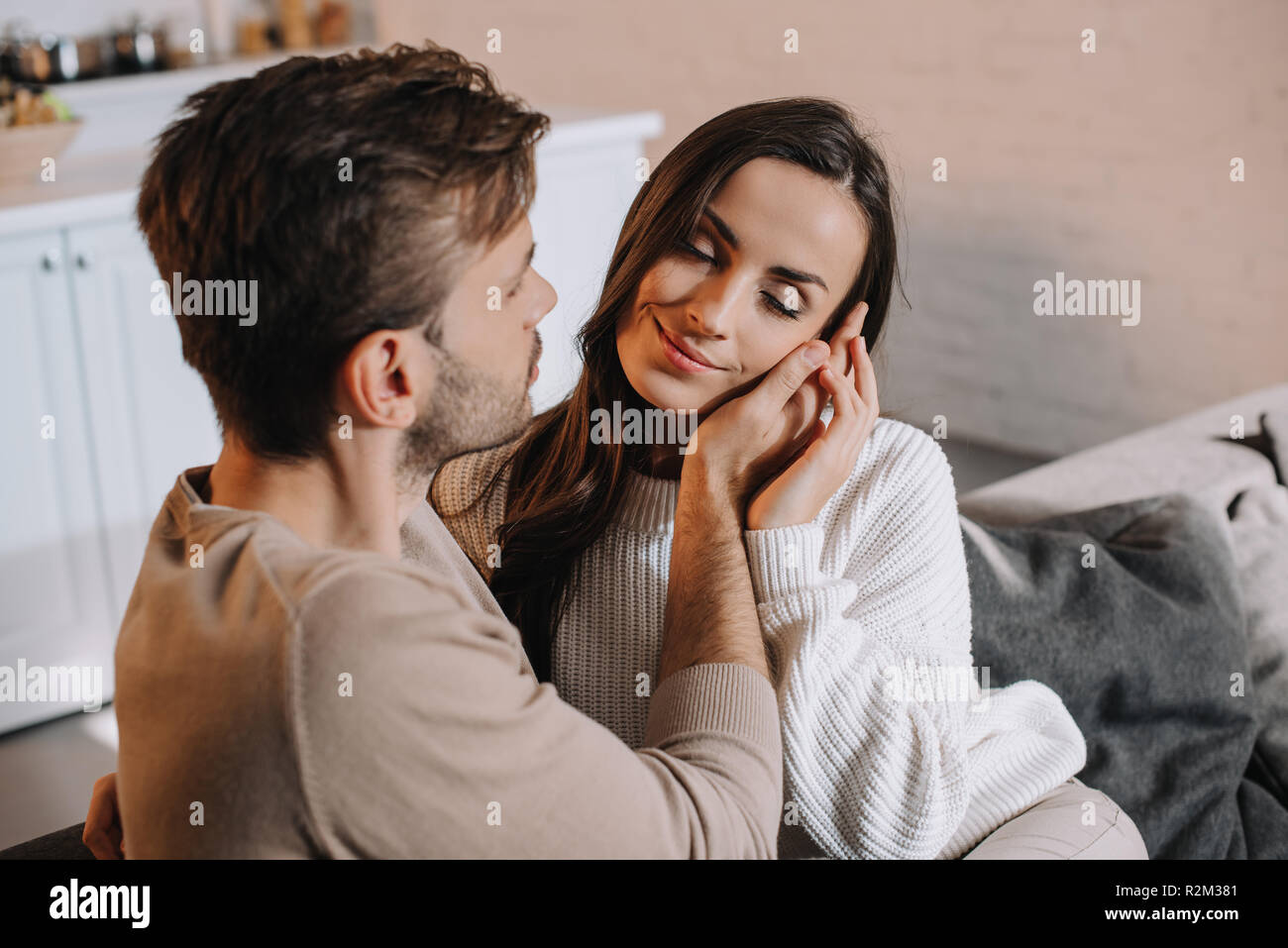 Couple cuddling on couch hi-res stock photography and images - Alamy
