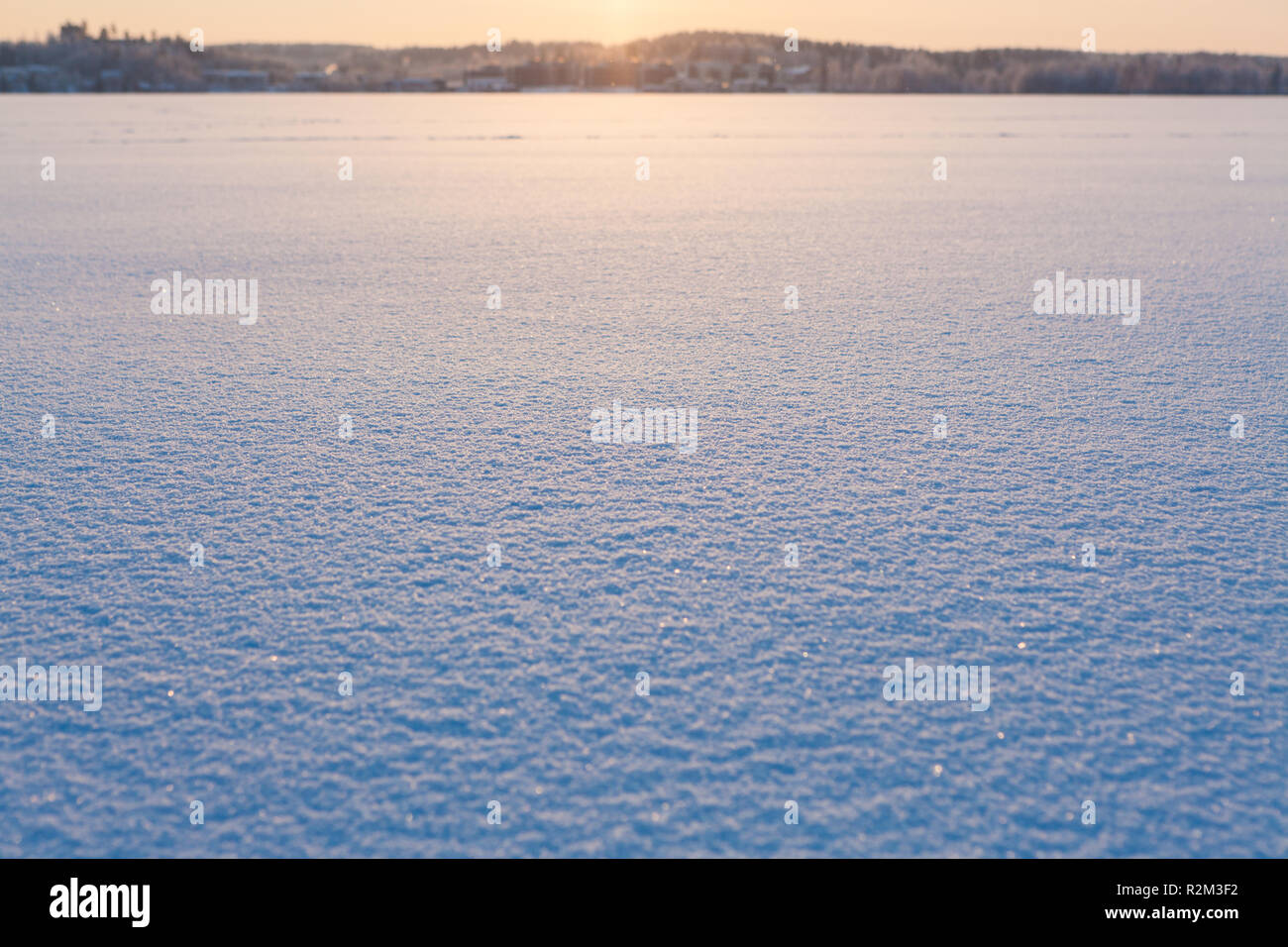 Snow surface at frozen lake sunset Stock Photo - Alamy