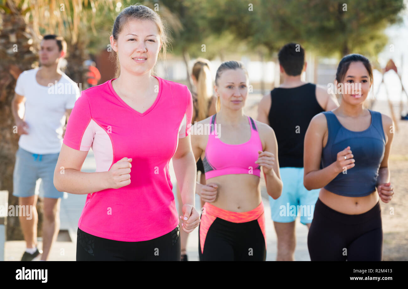 Active smiling people during running training in daytime Stock Photo ...
