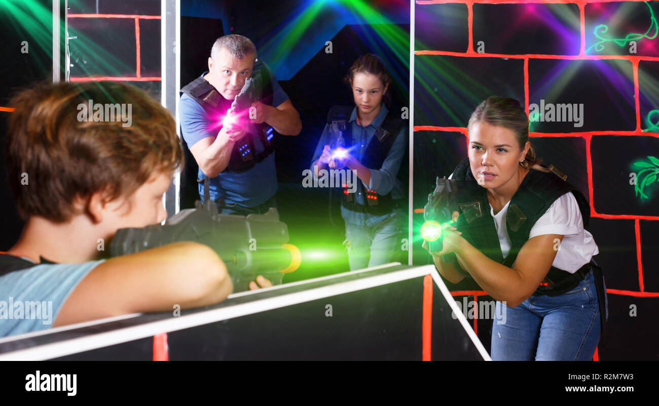 Group of happy kids and adults with laser pistols having fun on ...