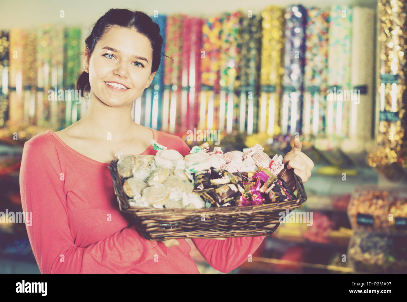 Photo of cheerful smiling girl in the shop with lots of sweets Stock ...