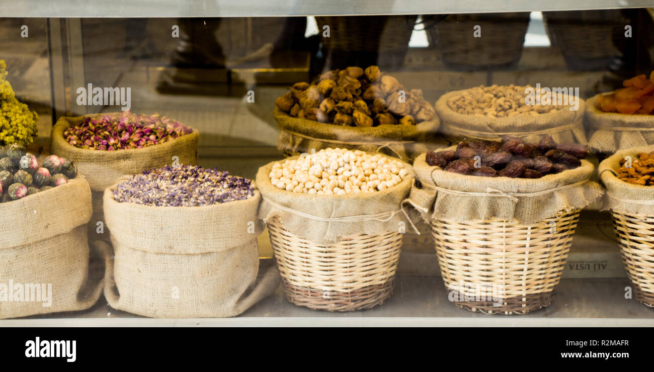 Almonds, figs, apricots, pistachios and herbal teas in straw baskets ...