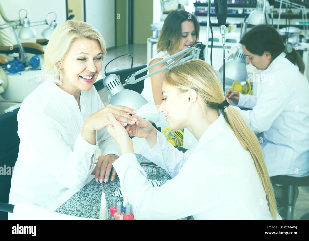 happy russian female clients doing nails in nail salon in afternoon ...