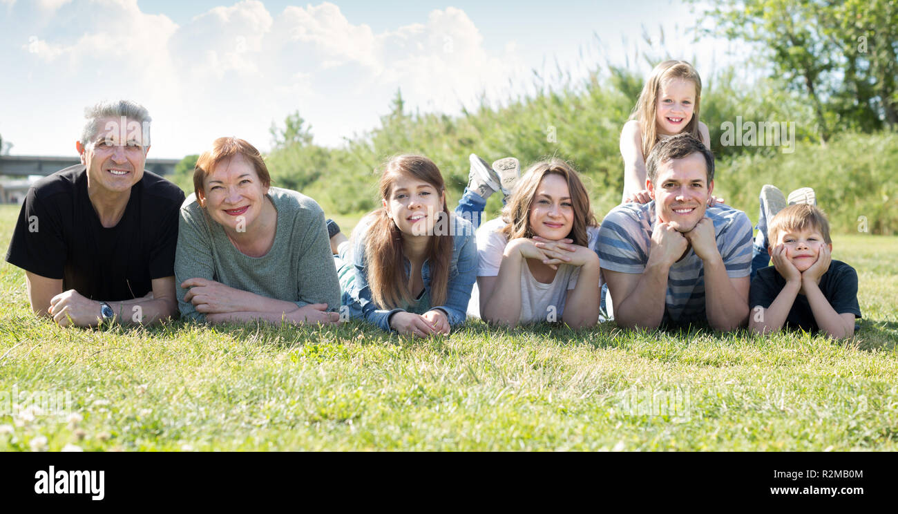 Happy people of different ages taking photos on the lawn Stock Photo ...