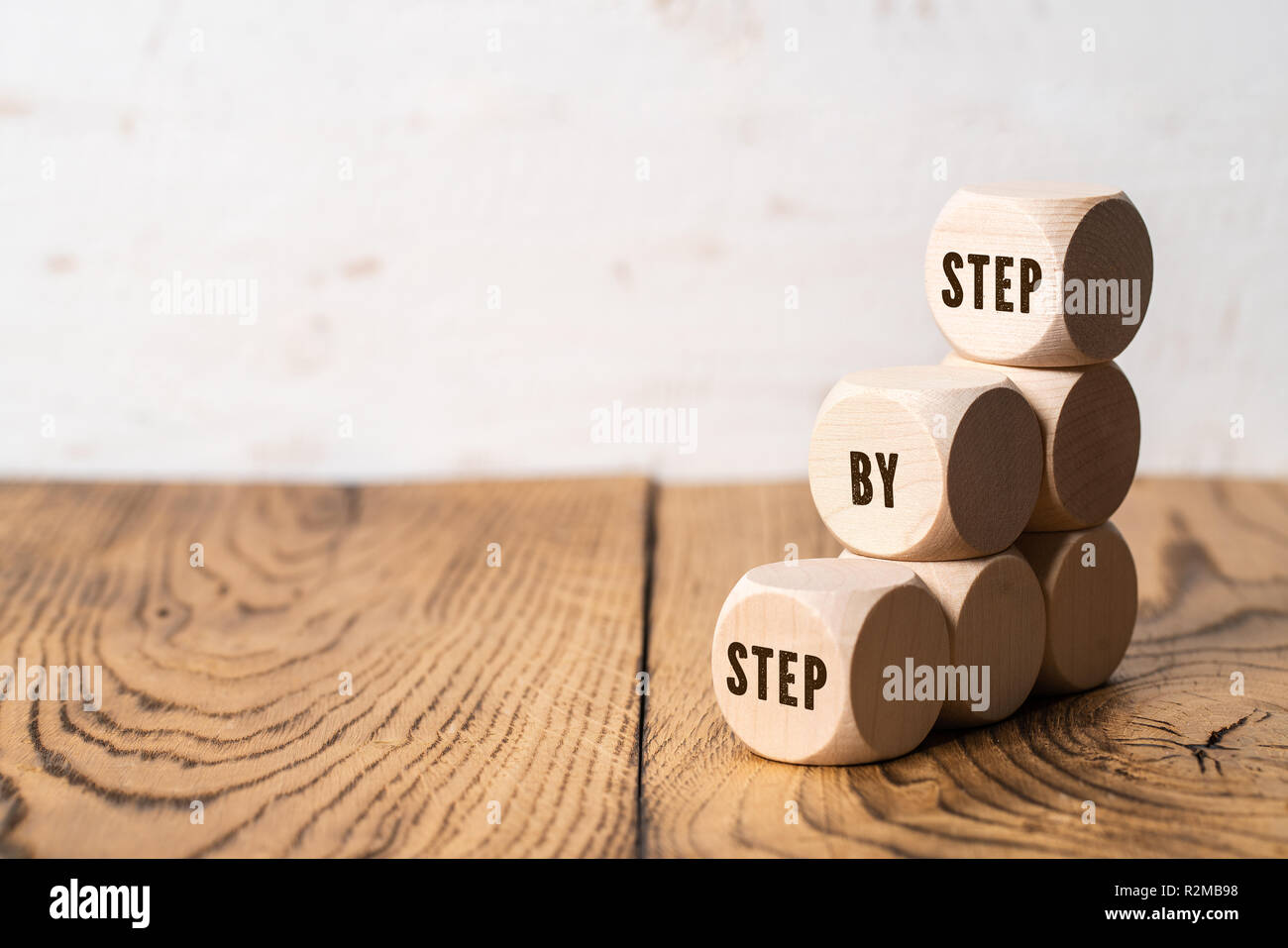 a stair symbolized by cubes and the slogan: step by step Stock Photo ...