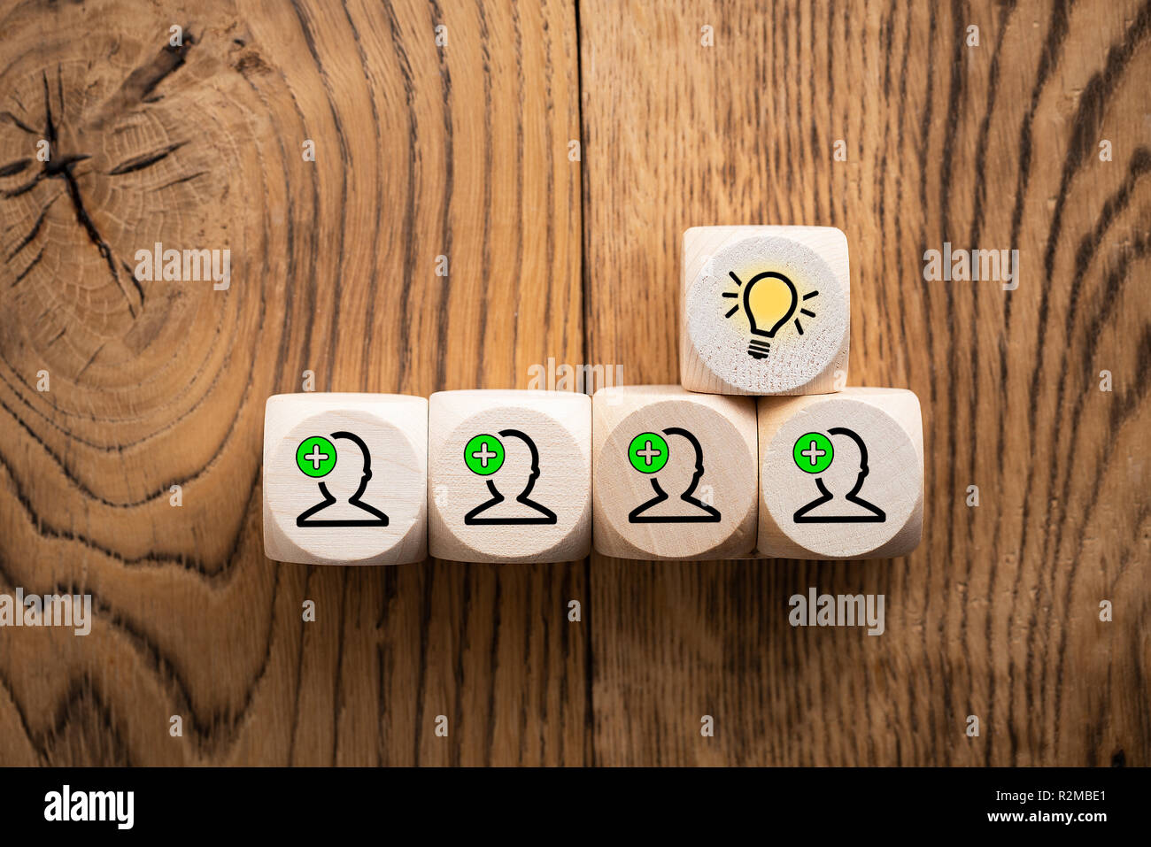 many people together having an idea symbolized by icons on cubes Stock ...