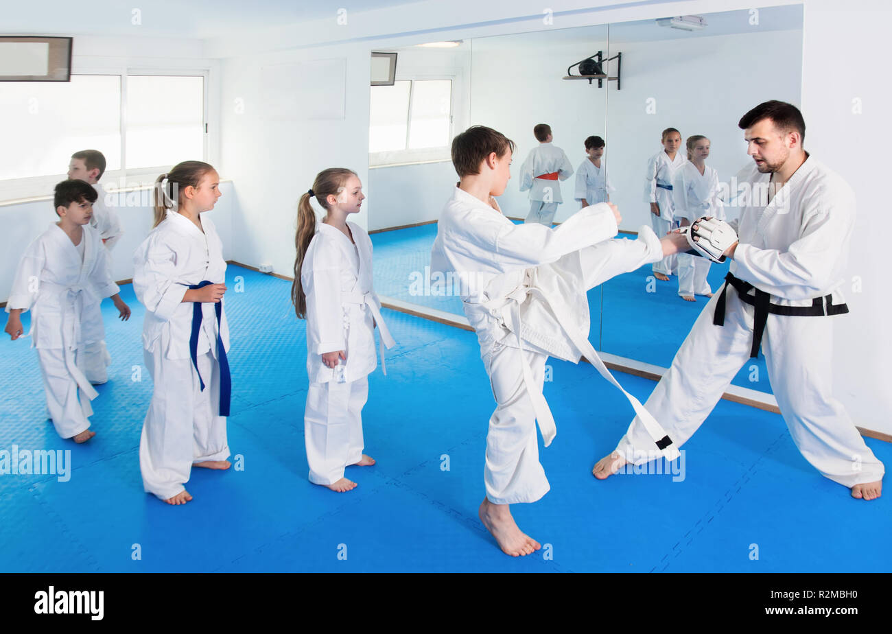 Positive children practicing karate moves at karate class Stock Photo ...