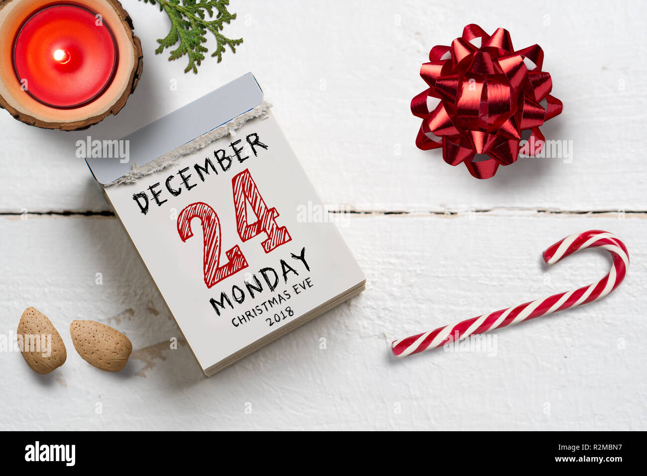 tear-off calendar with 24th of december on top on a wooden surface ...