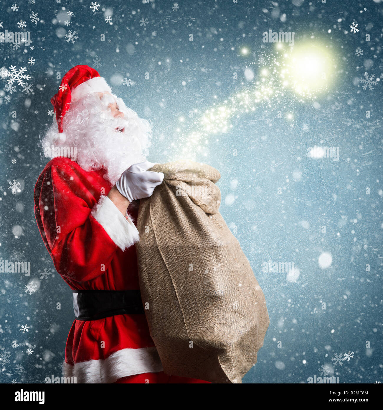 Santa Claus happily releasing some christmas magic Stock Photo - Alamy