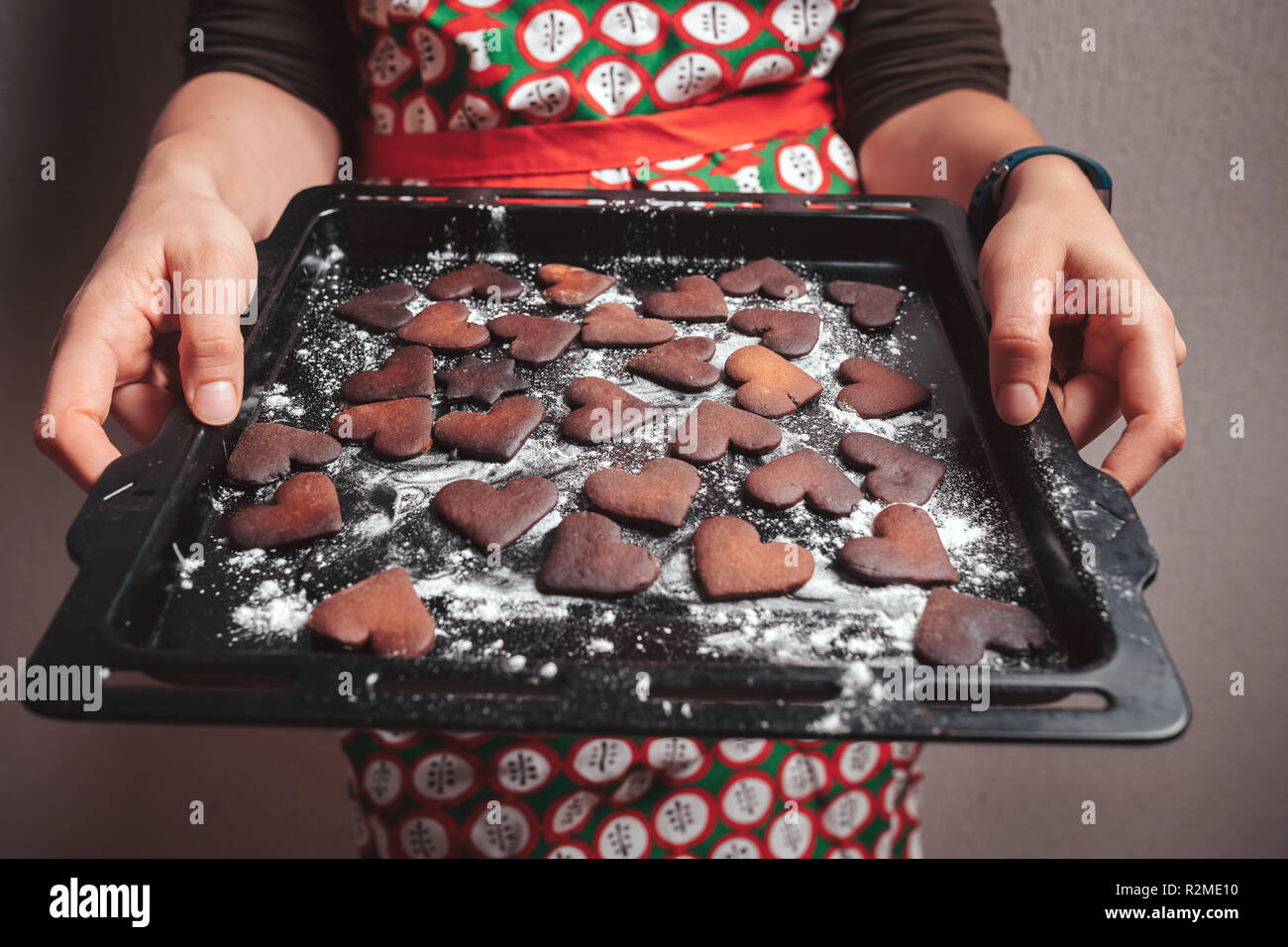 Girl holding baking tray with burnt gingerbread cookies Stock Photo - Alamy