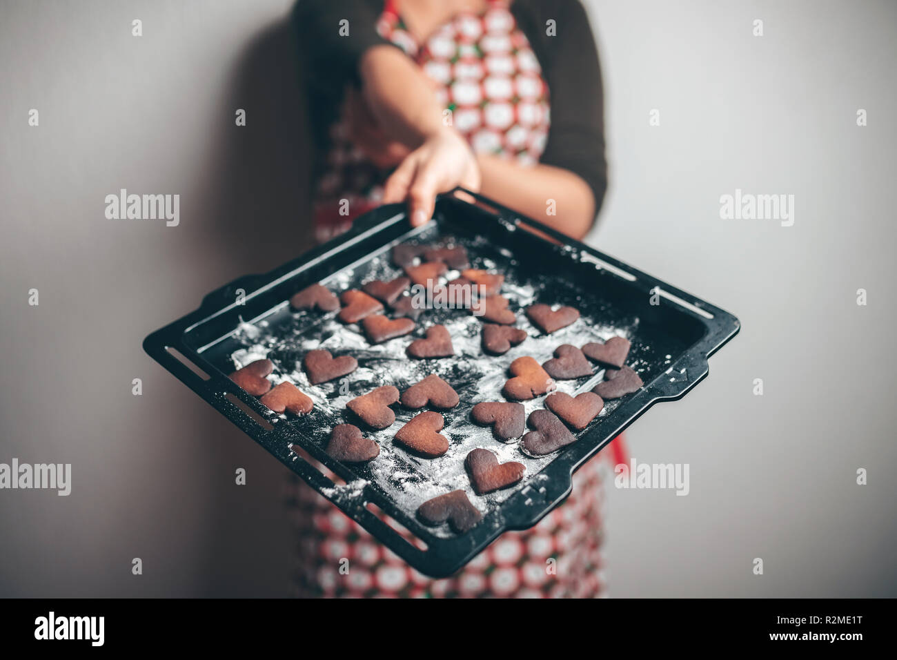 Girl holding baking tray with burnt gingerbread cookies Stock Photo - Alamy
