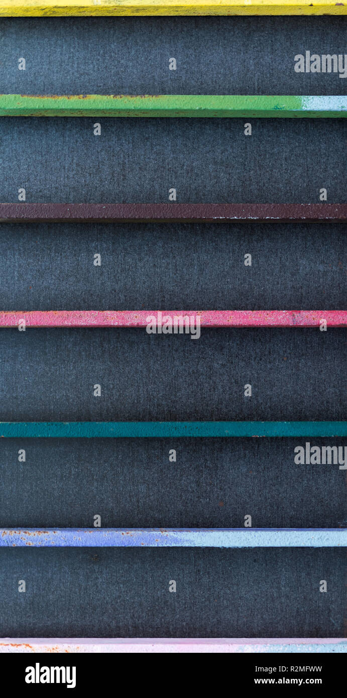 Colorful metal bars in front of a black background Stock Photo - Alamy