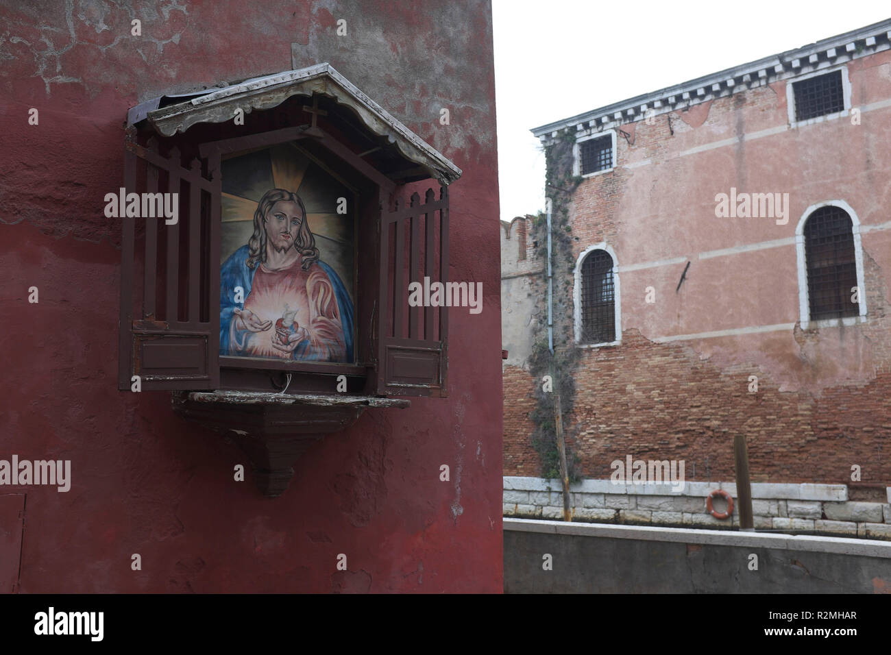 Prayer shrine on a facade in Venice Stock Photo - Alamy