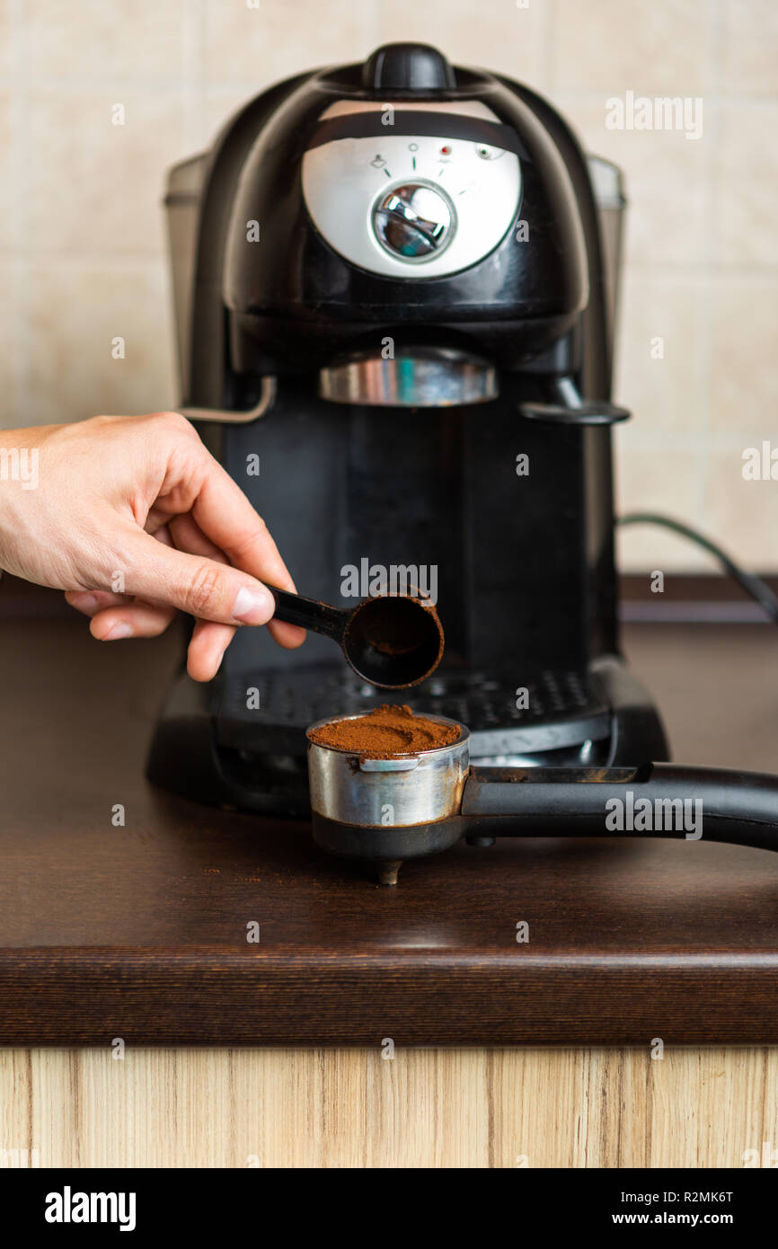 Photo of coffee maker, human hand pouring coffee into mug Stock Photo ...