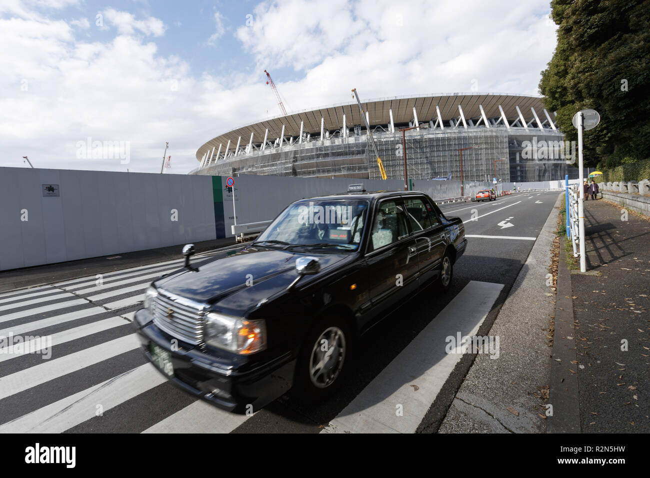 Tokyo, Japan. 20th Nov, 2018. A taxi runs past the New National Stadium ...