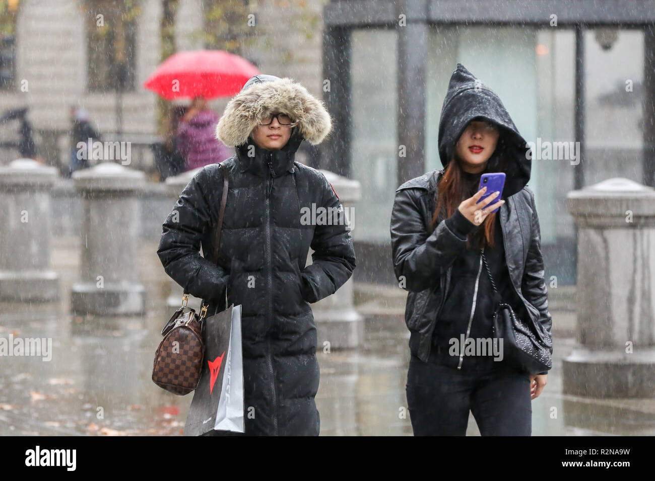 Two women sheltering from rain hi-res stock photography and images - Alamy