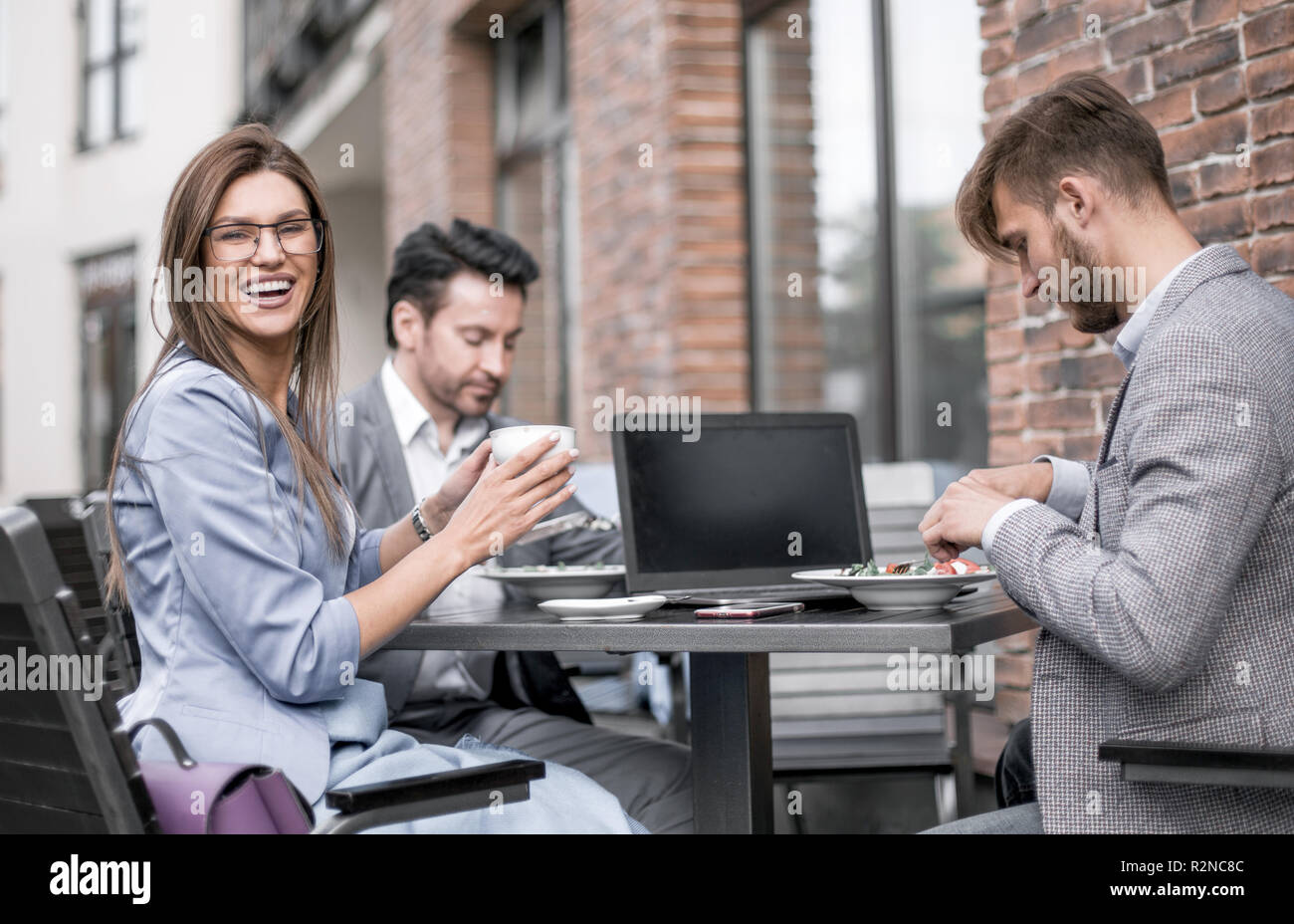 employees sitting at a table in a cafe Stock Photo - Alamy