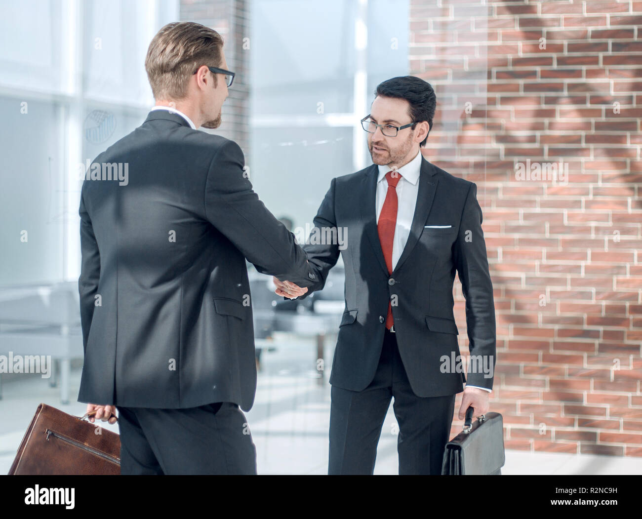 business hands shaking hands in the office hall Stock Photo - Alamy