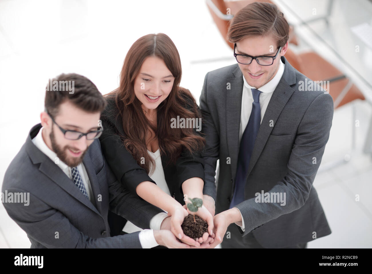Business team holding green hi-res stock photography and images - Alamy