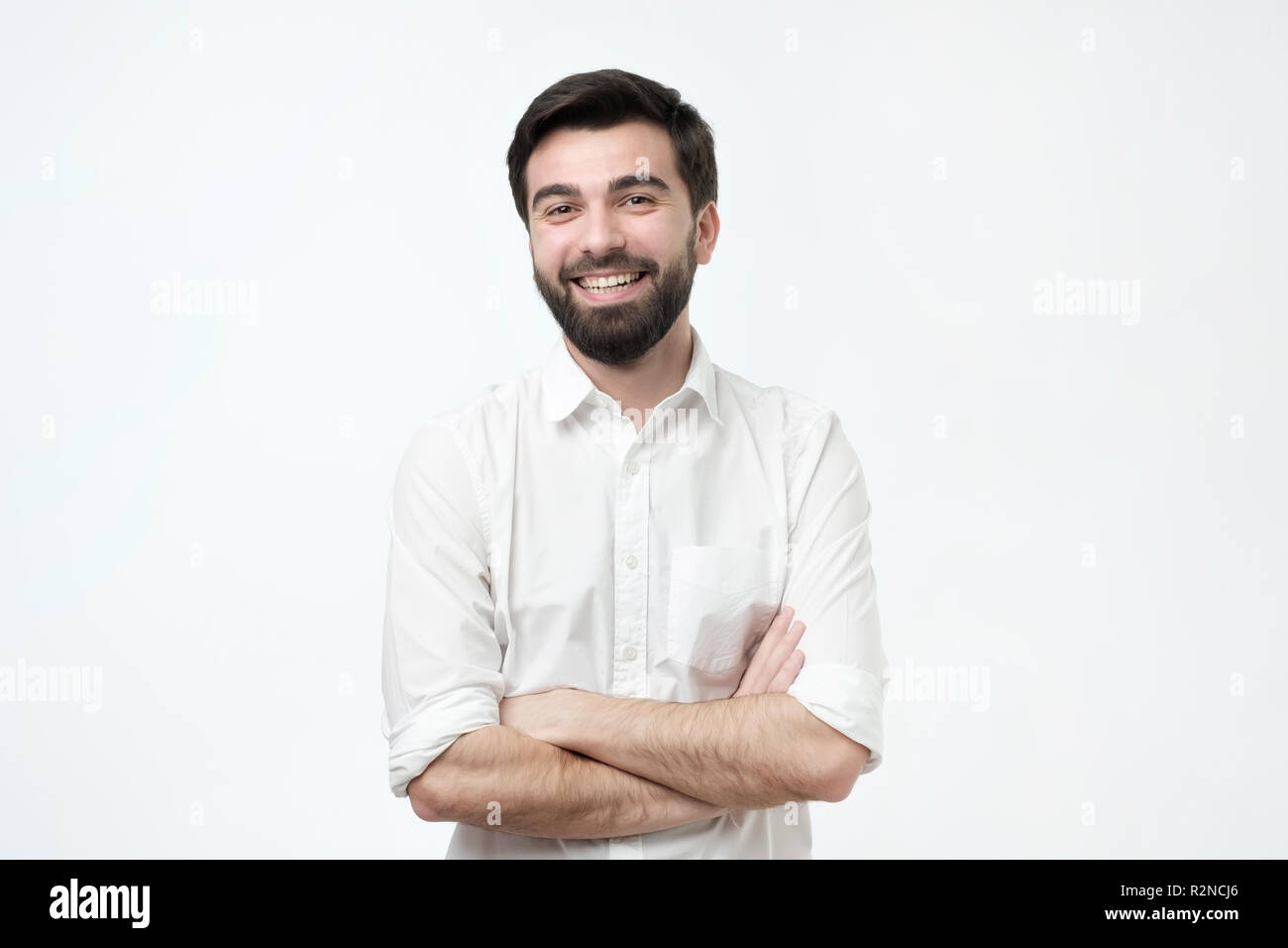 Portrait Of Smiling Handsome Man In White Shirt Standing With Crossed